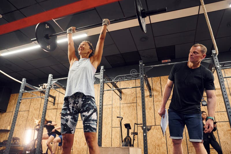 Strong Hands. Woman is Lifting Barbell in the Gym Stock Image - Image ...