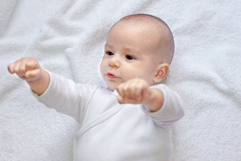 Strong Healthy Baby Looking at Fists Stock Image - Image of face, fists ...