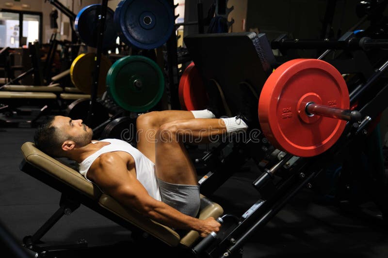 Strong Latin Man Doing Leg Press at a Gym. Stock Photo - Image of ...
