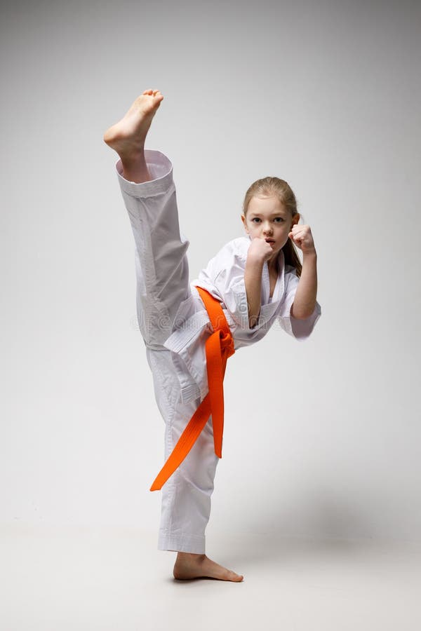 Strong Kick in a Karate Workout, a Child Girl in a Kimono Stock Image ...