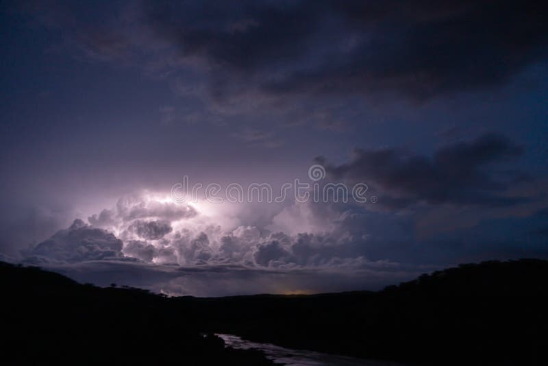 Strong Lightning in and Behind Big Towering Thunderclouds Stock Image ...