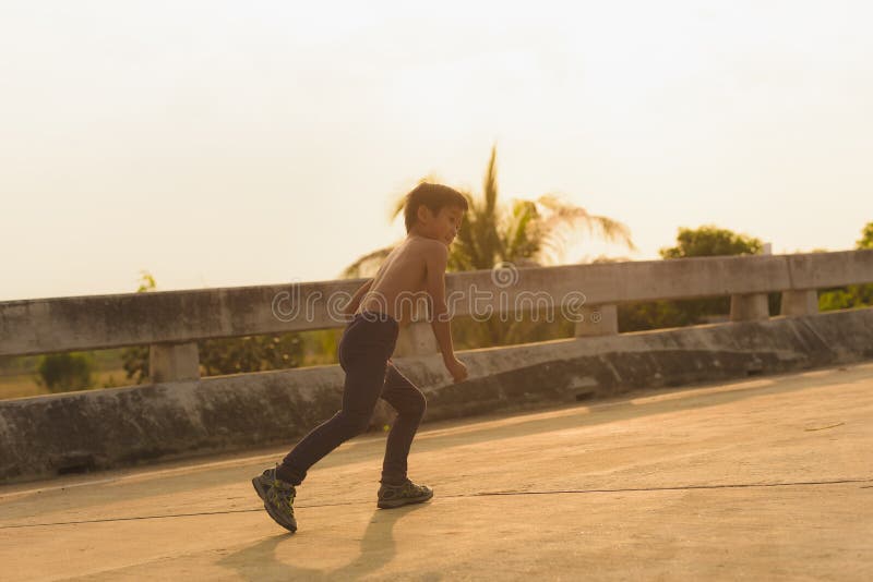 A Strong Little Boy Ran Along the Bridge Stock Image - Image of body ...