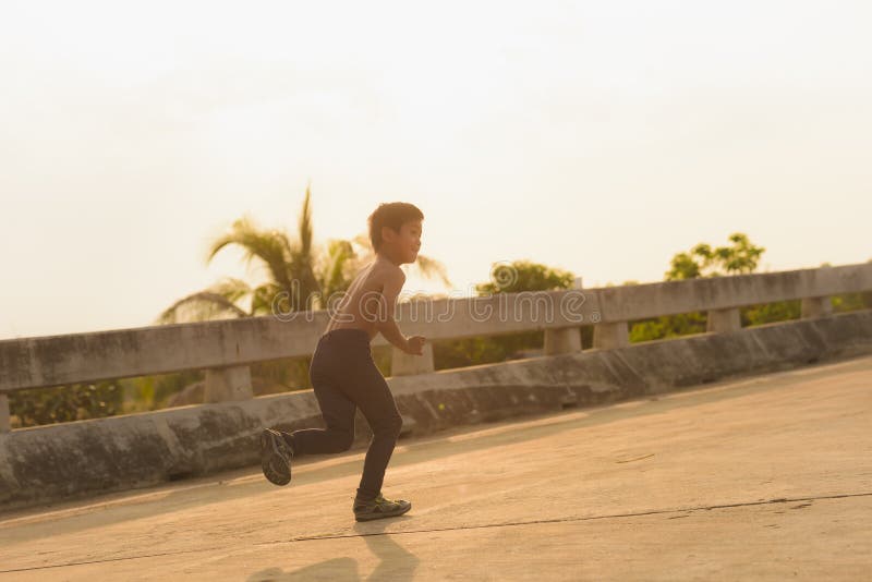 A Strong Little Boy Ran Along the Bridge Stock Photo - Image of ...