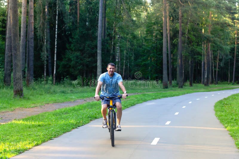 Strong Man on a Bike in the Park Stock Image - Image of park, leisure ...