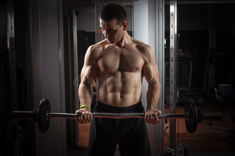 Strong Man - Bodybuilder with Dumbbells in Gym, Exercising with a ...