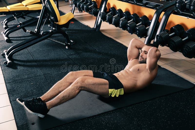 Strong Man Doing Crunches on Mat Stock Image - Image of floor ...