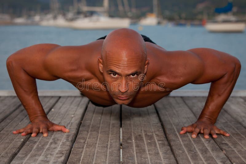 Strong man doing press ups stock photo. Image of recreation - 26189112