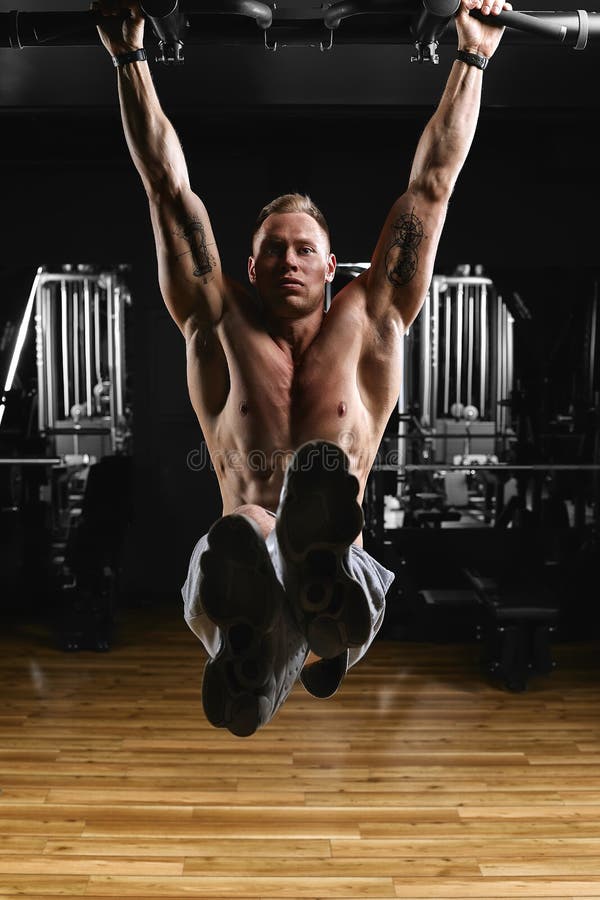 Strong Man Doing Pull-ups on a Bar in a Gym. Stock Image - Image of ...