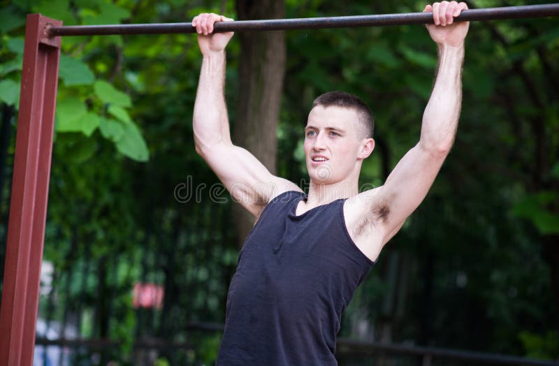 Strong Man Doing Pull-ups on a Bar Outdoor Stock Photo - Image of adult ...