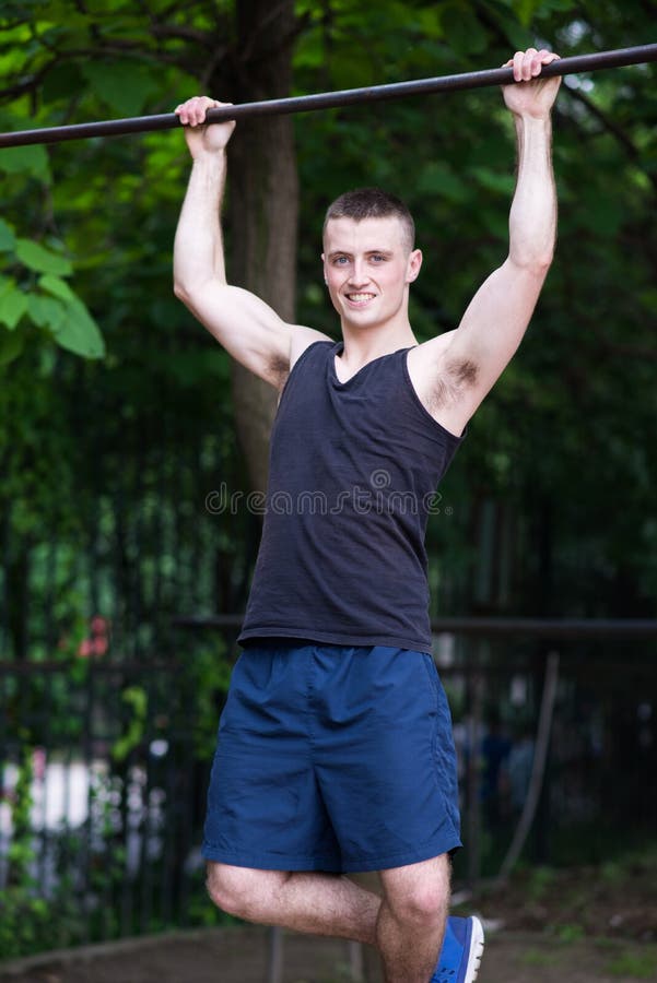 Strong Man Doing Pull-ups on a Bar Outdoor Stock Image - Image of ...