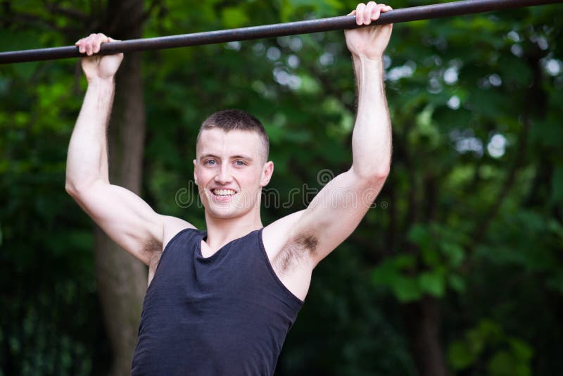 Strong Man Doing Pull-ups on a Bar Outdoor Stock Image - Image of arms ...