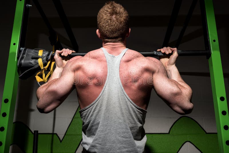 Strong Man Exercising in Dramatic Light Stock Photo - Image of focused ...