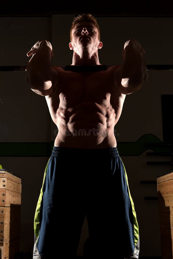 Strong Man Exercising in Dramatic Light Stock Image - Image of ...