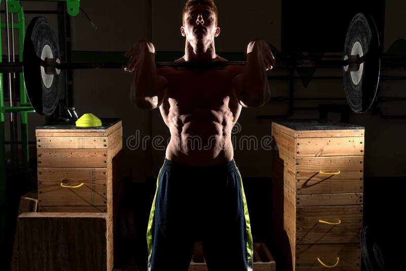 Strong Man Exercising in Dramatic Light Stock Image - Image of ...