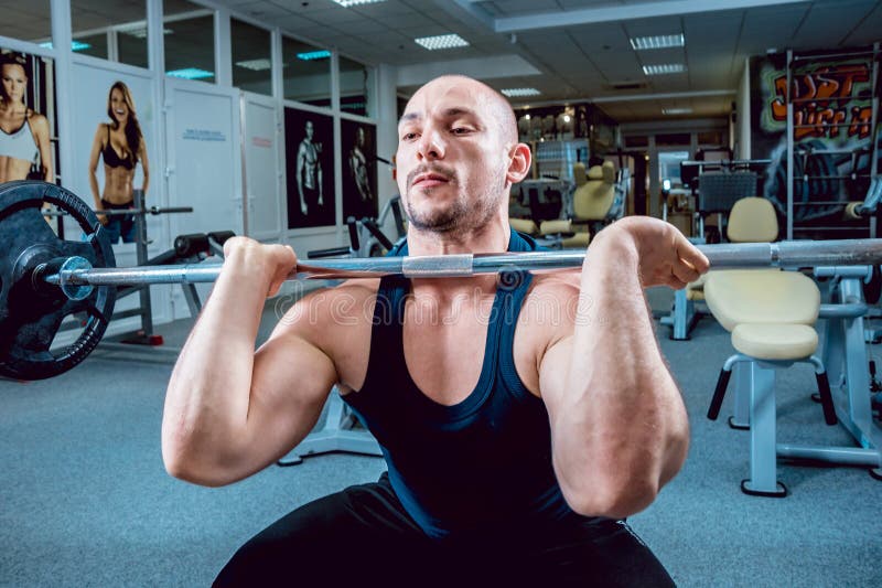 The strong man in the gym stock image. Image of equipment - 65239087