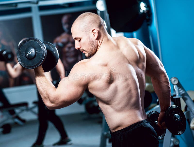 The strong man in the gym stock image. Image of males - 65240367