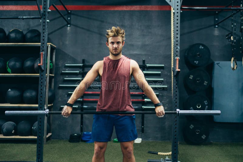 Strong Man Lifting a Barbell in a Gym Stock Image - Image of ...