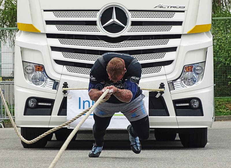 A Strong Man Pulls a Big Truck Editorial Photography - Image of extreme ...