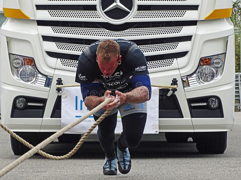 A Strong Man Pulls a Big Truck Editorial Photo - Image of powerful ...