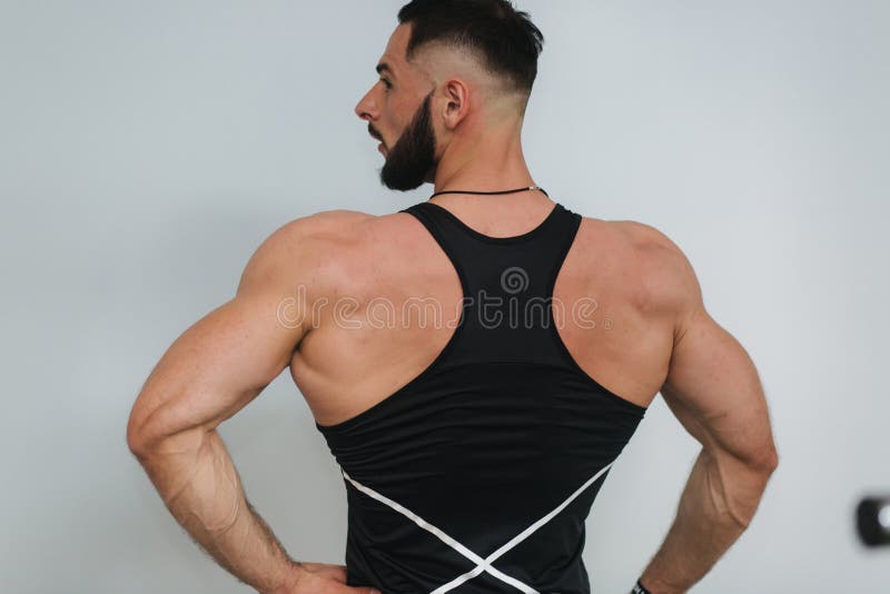 Strong Man Show His Back Muscules on Grey Background Stock Photo ...