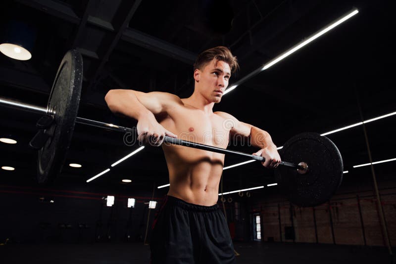 Strong Man Working Out at a Gym with Bar Plate. Pulls Up. Stock Image ...
