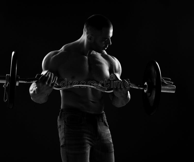 Strong Men Athlete, Bodybuilder, Does Exercises for Biceps, Looking at ...