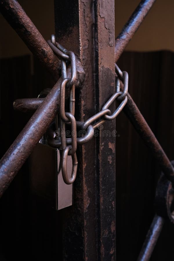 Lock and Strong Steel Chain Wrapped Around the Metal Entrance Gate ...