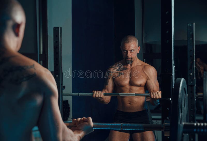 Strong Muscular Man Trains in the Gym Stock Photo - Image of background ...
