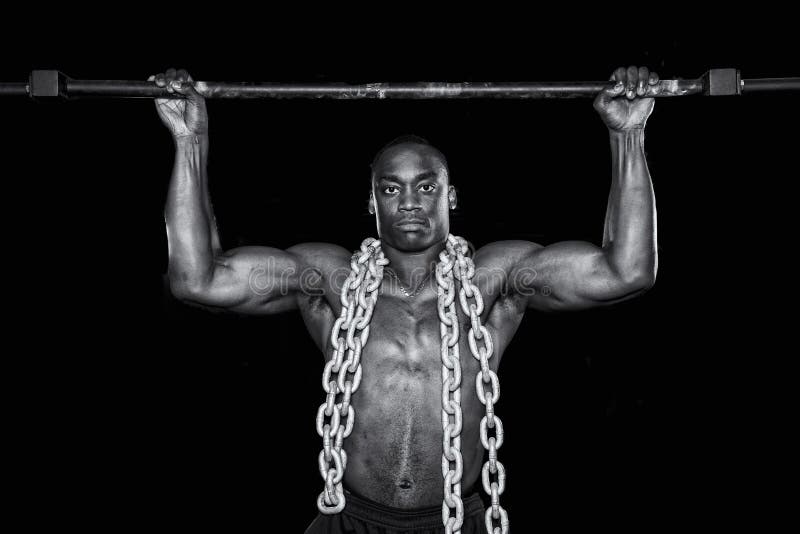 Strong man does a pull up stock image. Image of heavy - 27977917