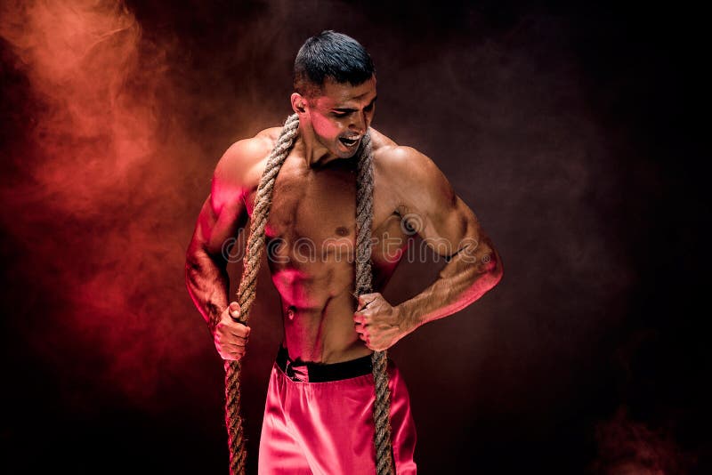 Strong man with rope stock image. Image of health, masculine - 101938897