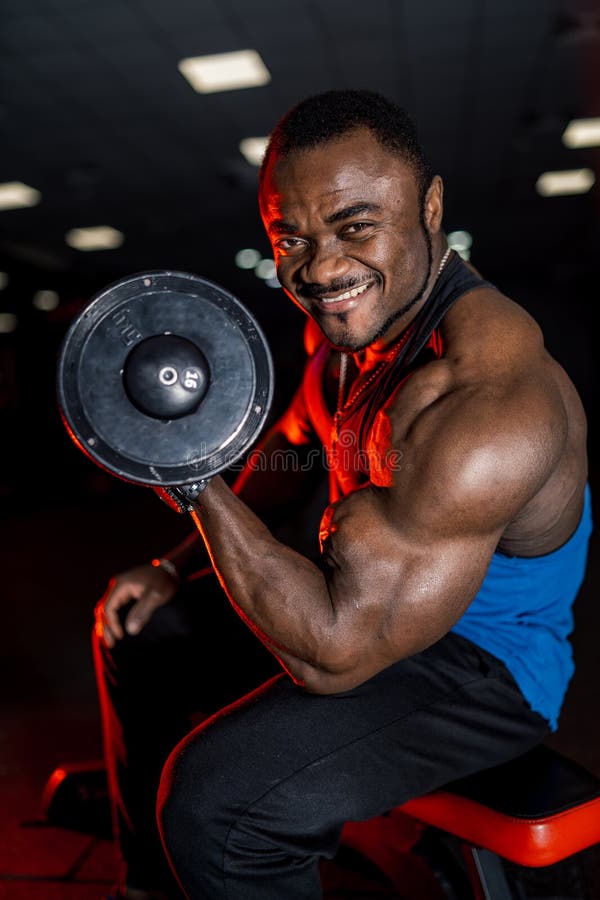 Strong Smiling Bodybuilder in Blue Tshirt Exercising with Heavy ...