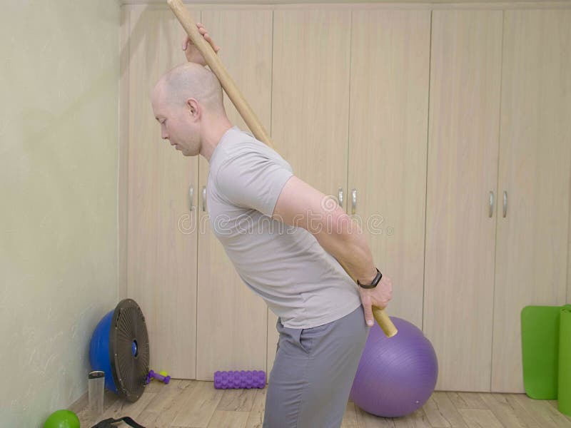 Strong Sport Man Holds a Gymnastic Stick on Back. Correct Posture ...