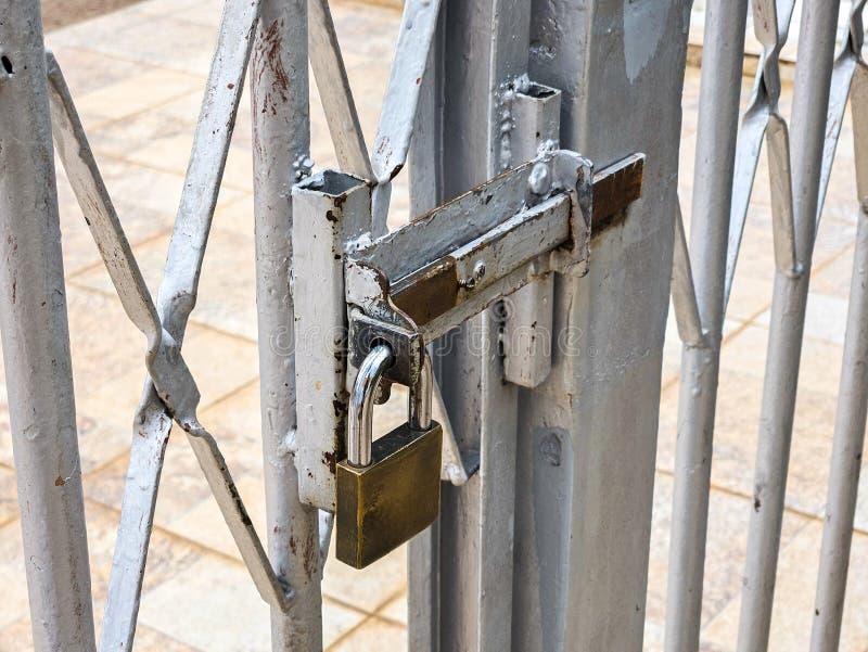 Strong Steel Grid Gate Fastened with a Padlock, Symbolizing Security ...