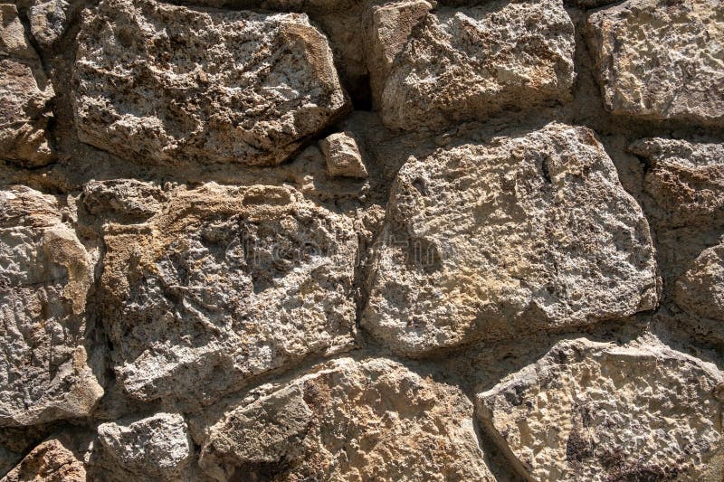Detailed View of a Weathered Stone Wall Showcasing Unique Textures and ...