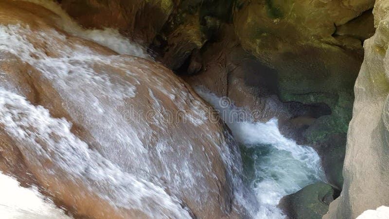 Strong Water Flow in the Cave. a Small Waterfall Underground Stock ...