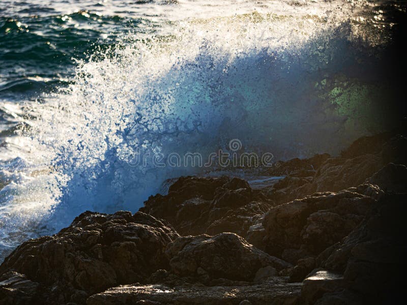 Strong Wave Splashing Against a Rock in the Sea Stock Photo - Image of ...