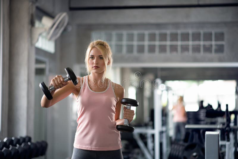 Strong Woman Doing Exercises with Dumbbells in Gym Stock Photo - Image ...