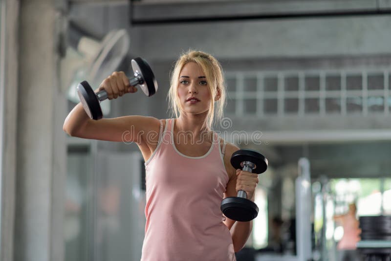 Strong Woman Doing Exercises with Dumbbells in Gym Stock Image - Image ...