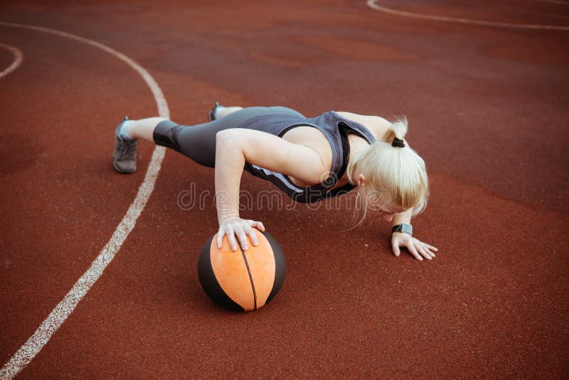 Strong Woman Doing Seated Medicine Ball Push-ups. Stock Photo - Image ...
