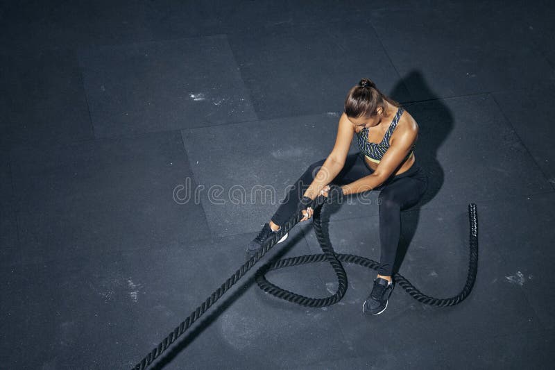 Power Caucaian Woman Functional Training with Black Rope at a Gym. Copy ...