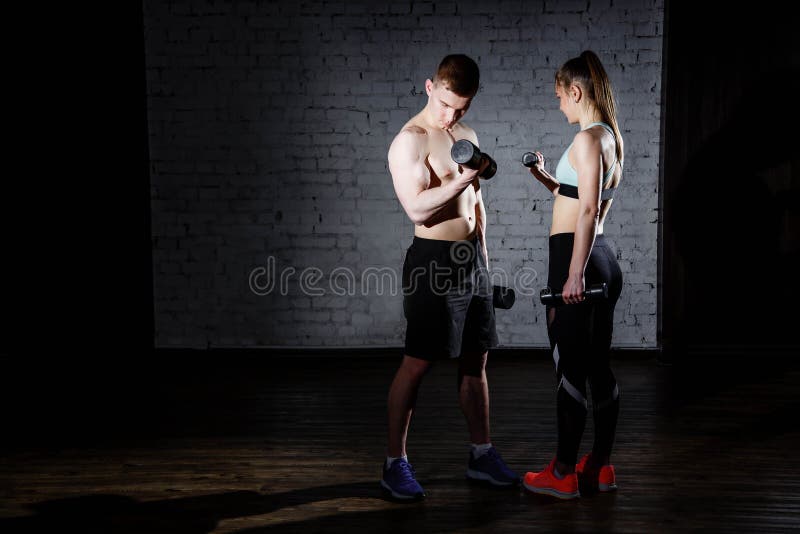 Strong Young Couple Working Out with Dumbbells. Bodybuilders Stock ...