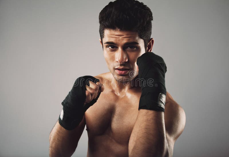 Fit Young Man Wearing Boxing Gloves Looking Down Stock Image - Image of ...