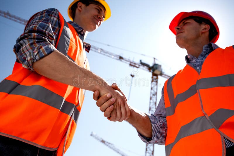 Two Builders Shake Hands Over Blueprint Stock Image - Image of ...