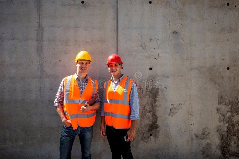 Structural Engineer and Architect Dressed in Orange Work Vests and ...