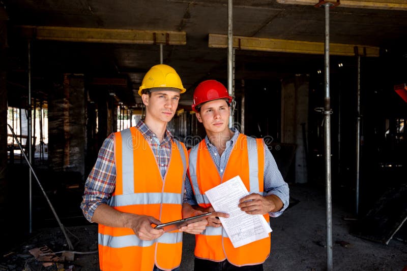 Structural Engineer and Architect Dressed in Orange Work Vests and ...