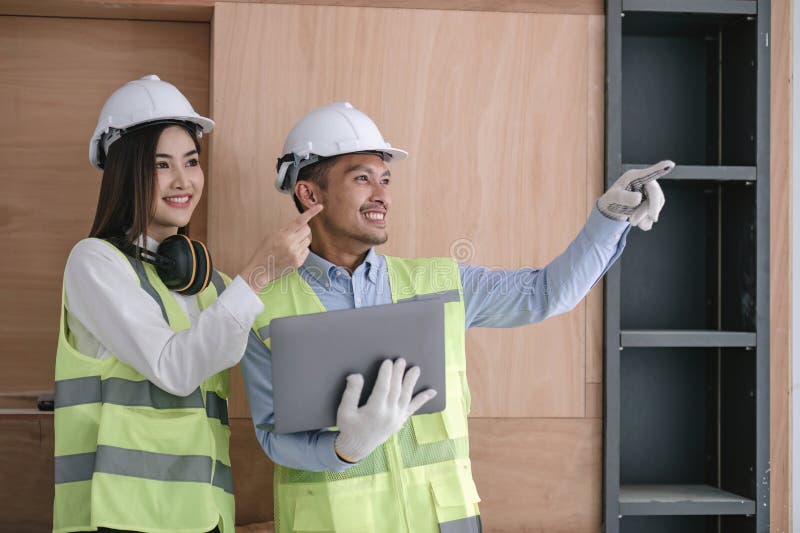 Structural Engineer and Architect Dressed in Reflective Vests Discuss ...