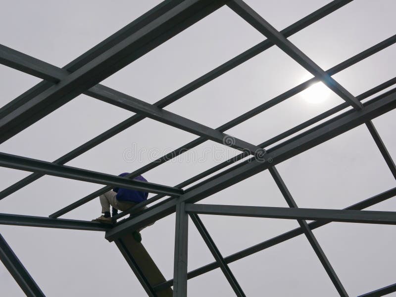 A Structural Steel Worker Working on a High Rooftop for a House Roof ...