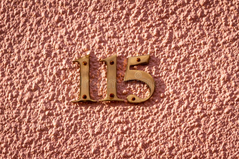 Golden House Number 115 on a Pink Plaster Wall Stock Photo - Image of ...