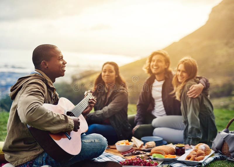Strumming in the Sunshine. a Group of Young Friends Having Fun at a ...