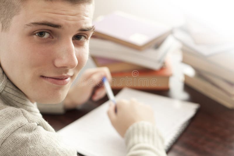 Young Man Doing Homework and Studying in College Library Stock Photo ...